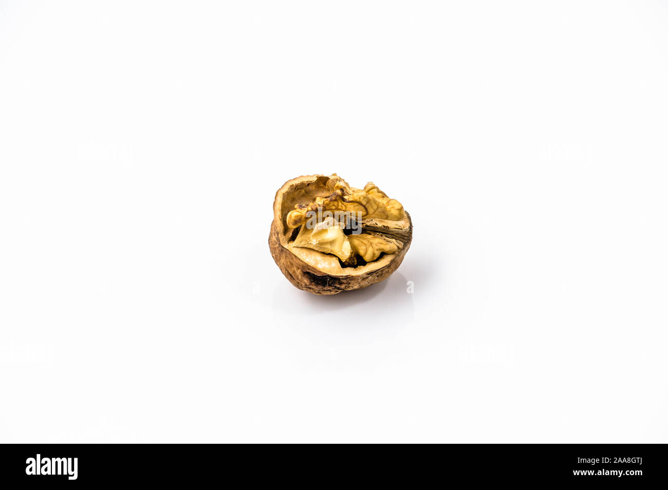 Cracked walnut on a white background Stock Photo - Alamy