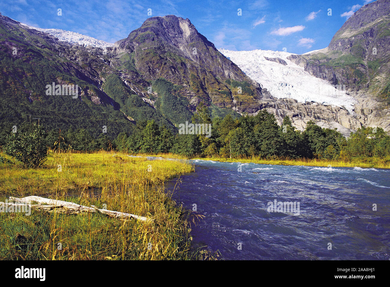 The Boyabreen Glacier falling steeply between two rocky peaks, and the ...