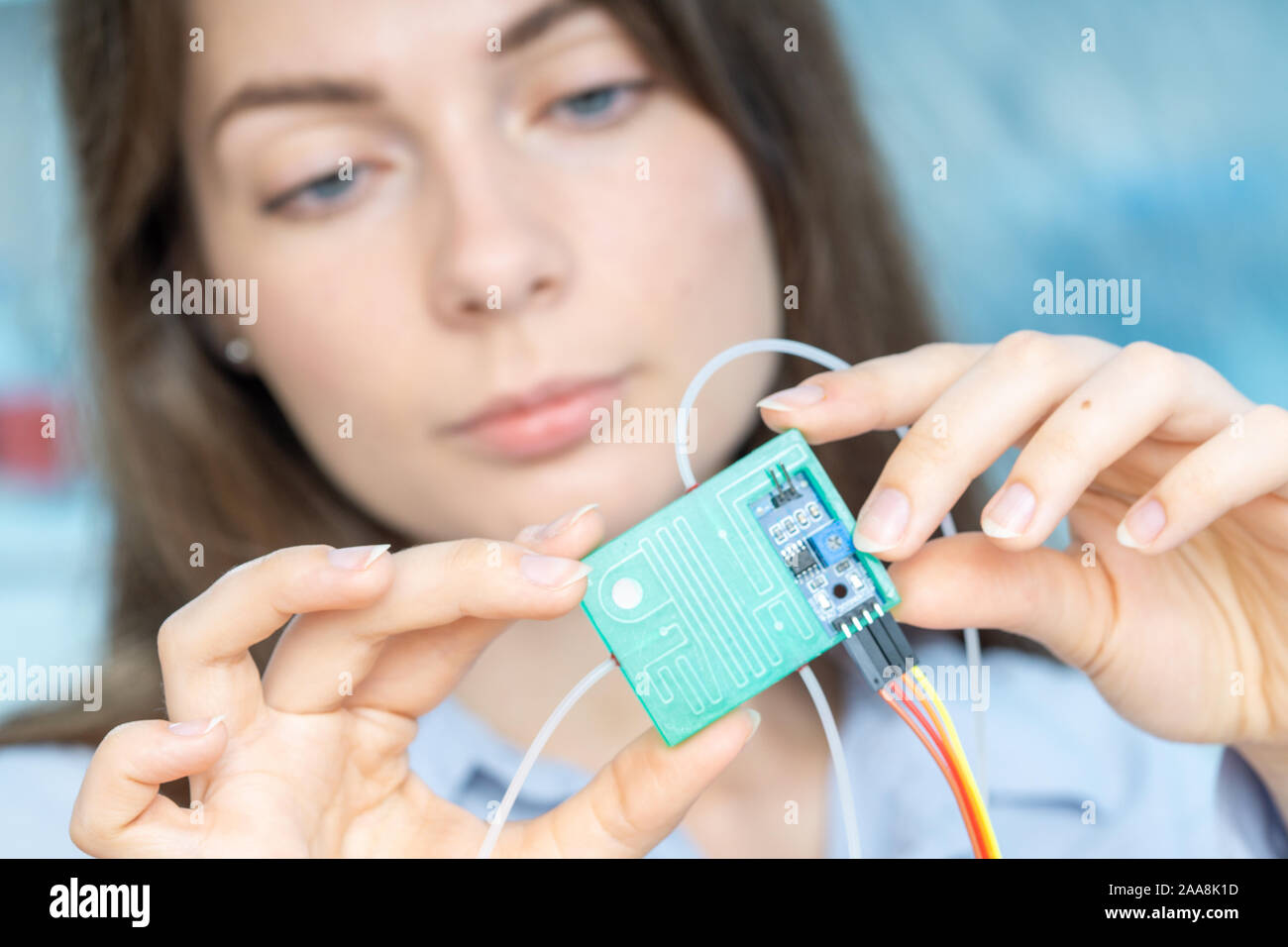 Young scientist woman in microbiological lab with lab-on-chip LOC ...