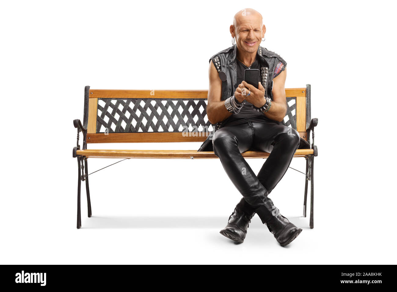 Punker using a smartphone and sitting on a bench isolated on white ...
