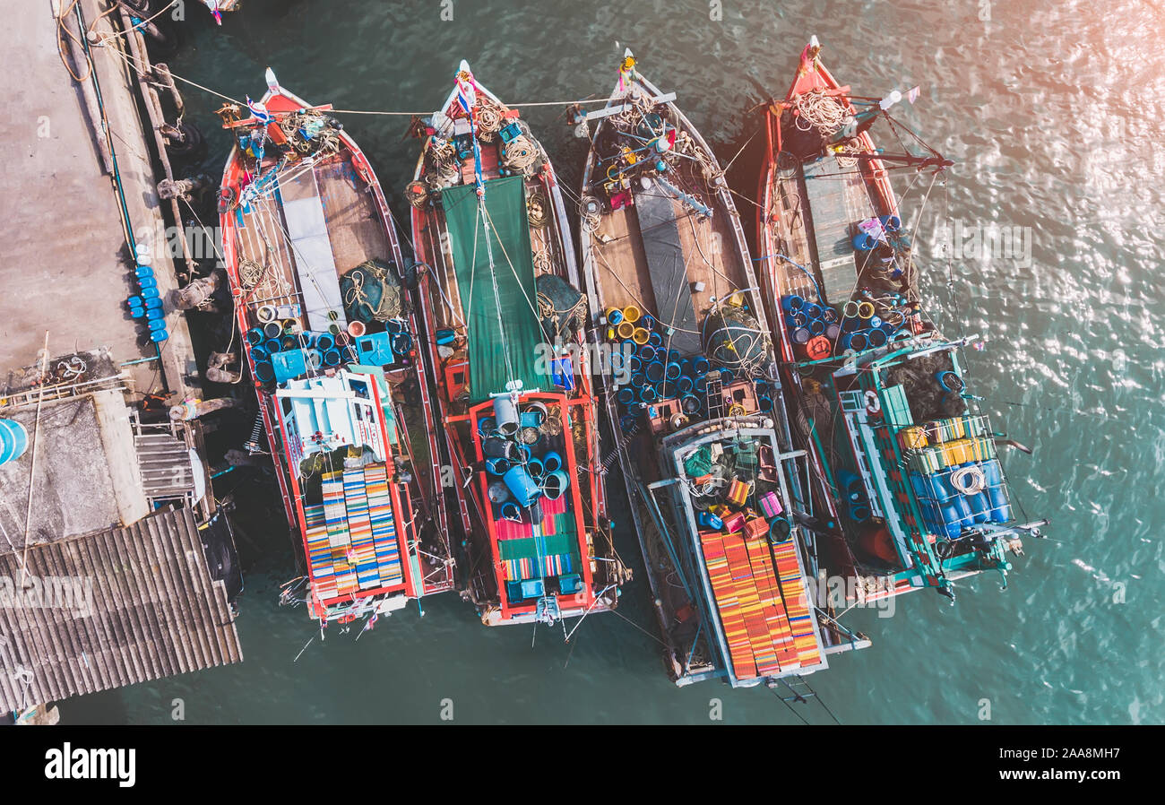 Top view from sky of group of wooden fishery boat at the sea marina ...