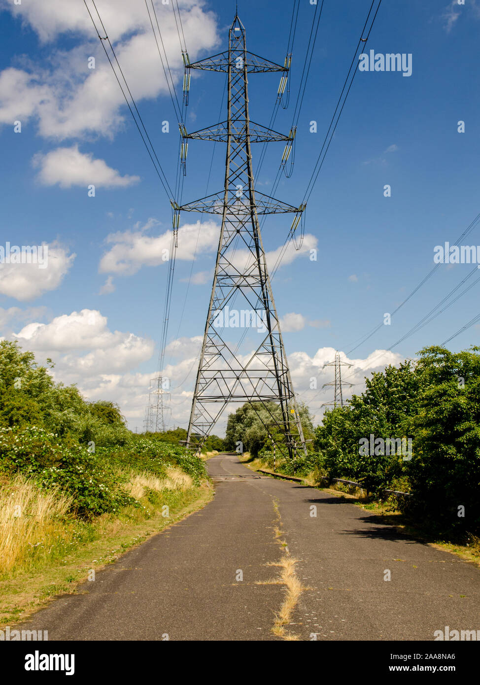 Electricity pylons carry National Grid power lines across wasteground ...