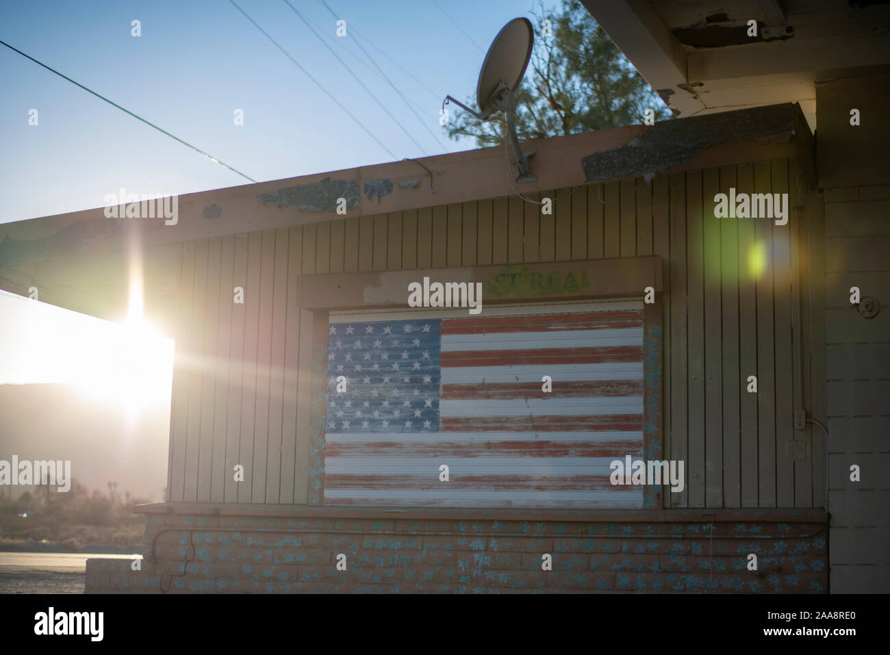 Desert home with a American flag murial Stock Photo - Alamy