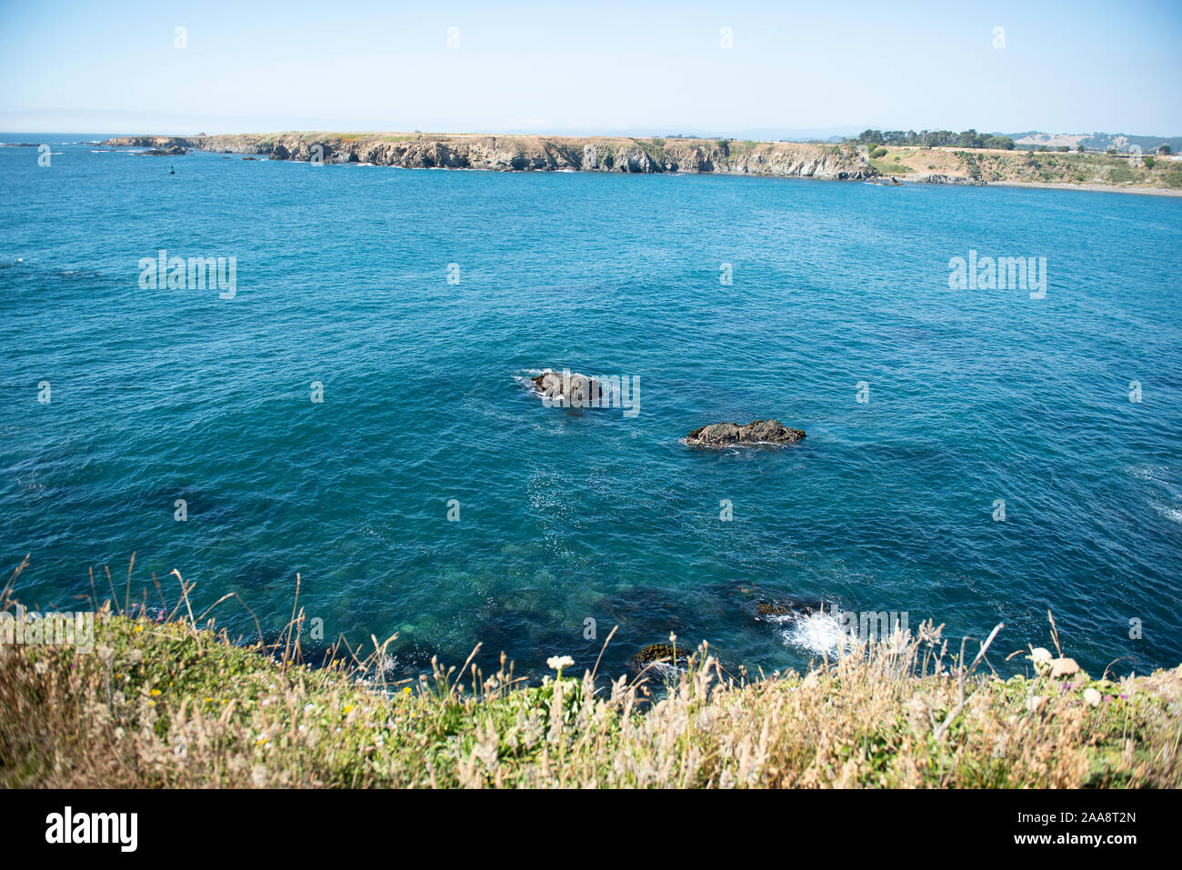 Beautiful blue water bay on California Coast Stock Photo - Alamy