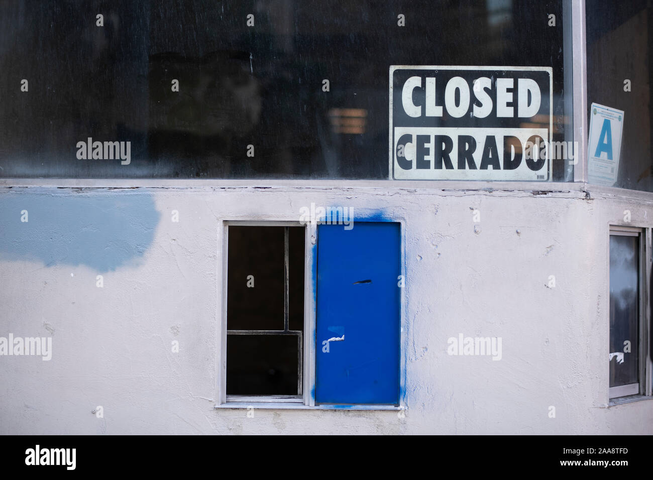 Closed Taco shop, rundown take out window with blue spray paint Stock ...