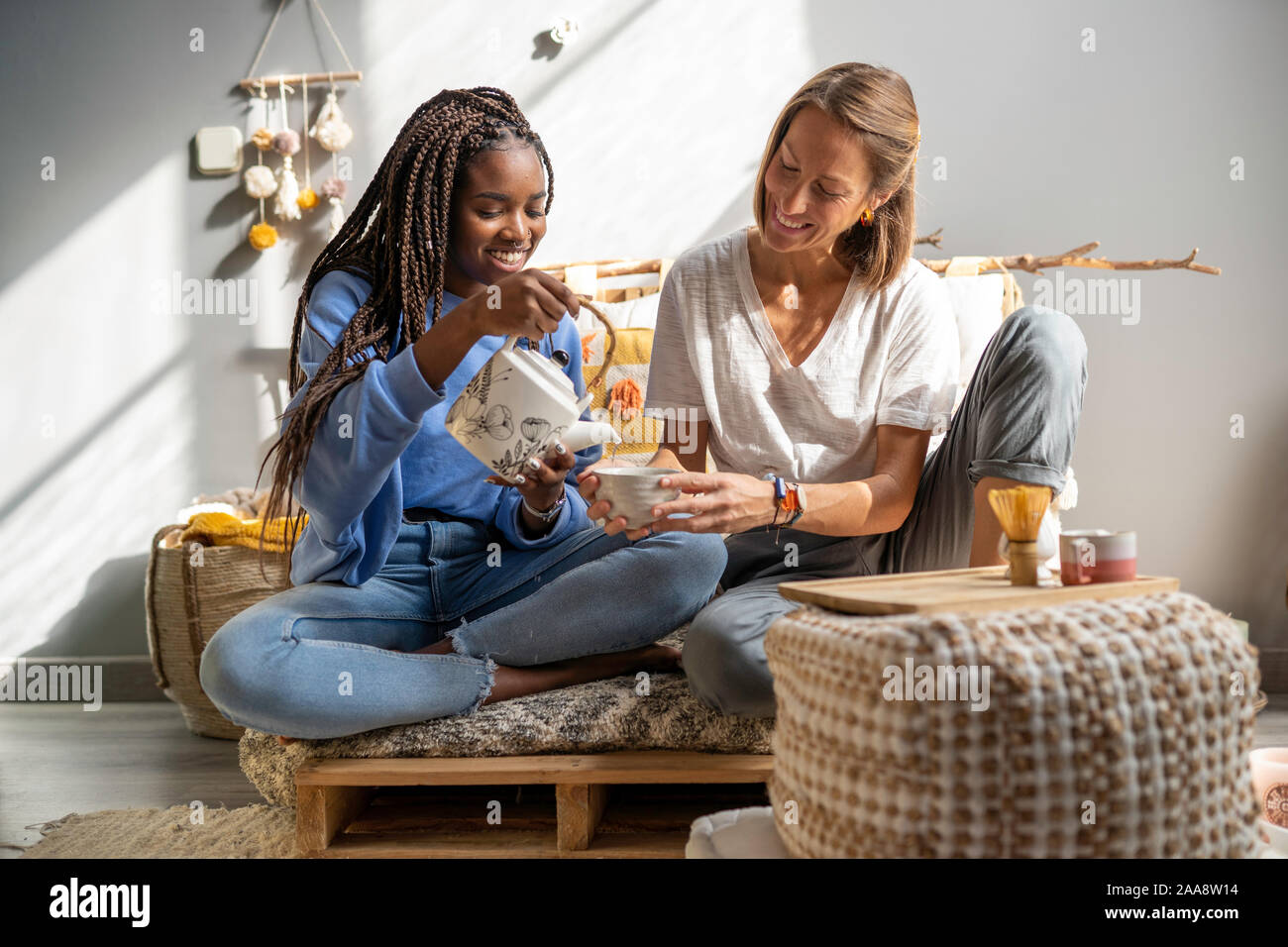 Two friends drinking tea at home Stock Photo - Alamy