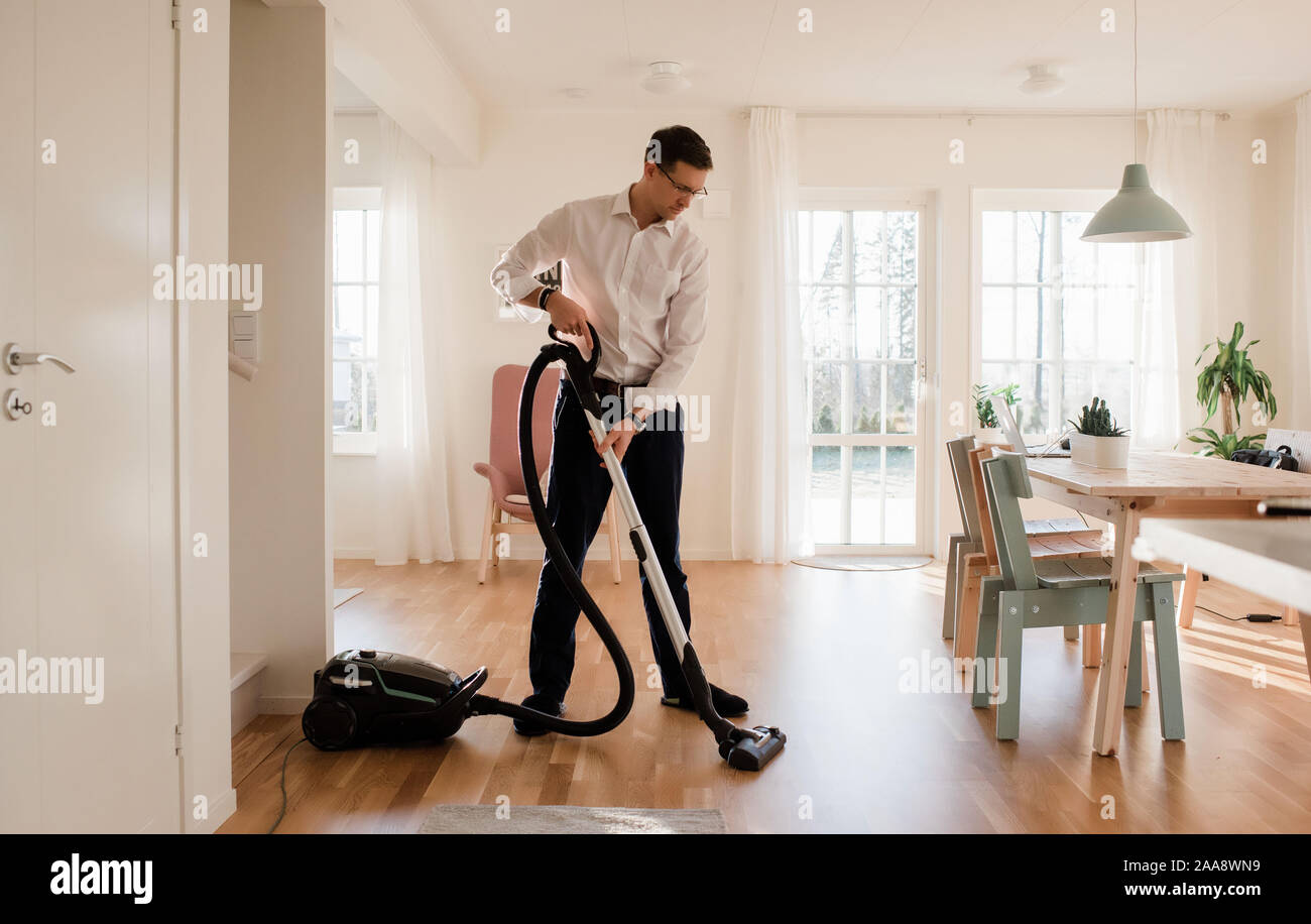 Man hoovering room hi-res stock photography and images - Alamy