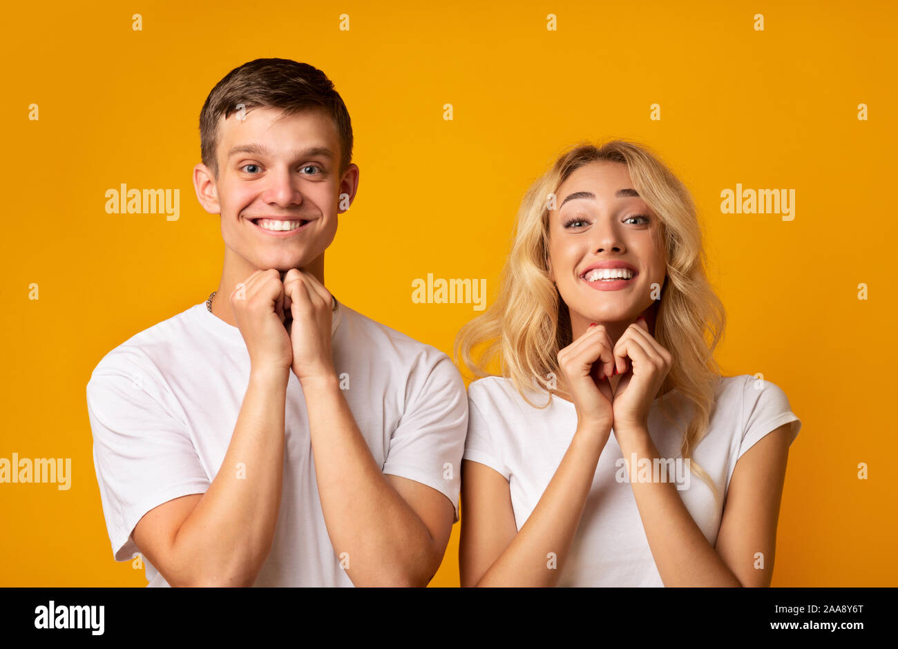 Young guy and girl pleading for something with clasped hands Stock ...