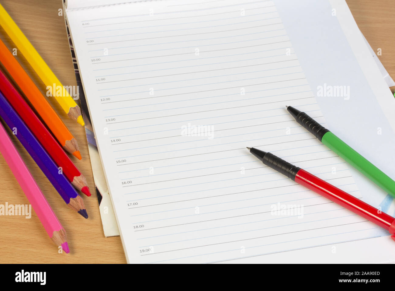 Opened business diary, pens and markers Stock Photo - Alamy