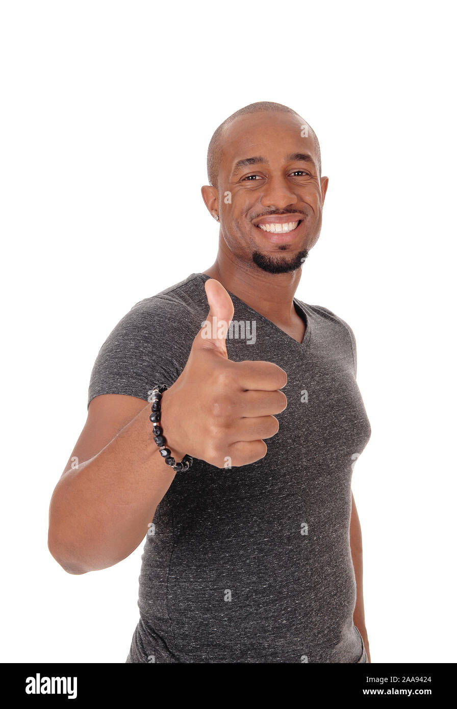 A smiling African American man standing in a sweater pointing with his ...