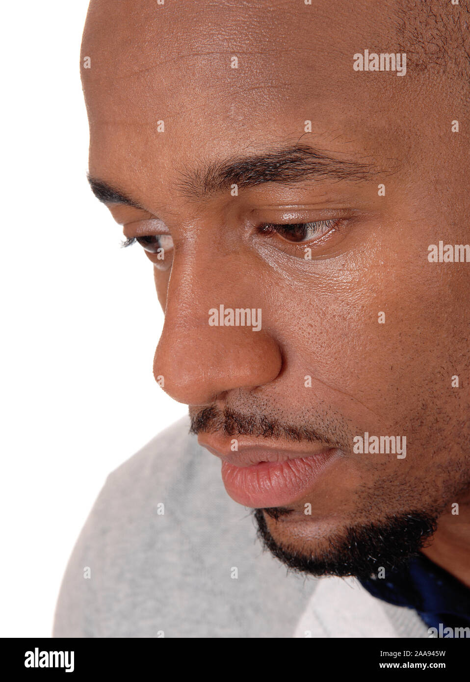An Close Up Image Of The Face Of An African American Man Looking Down