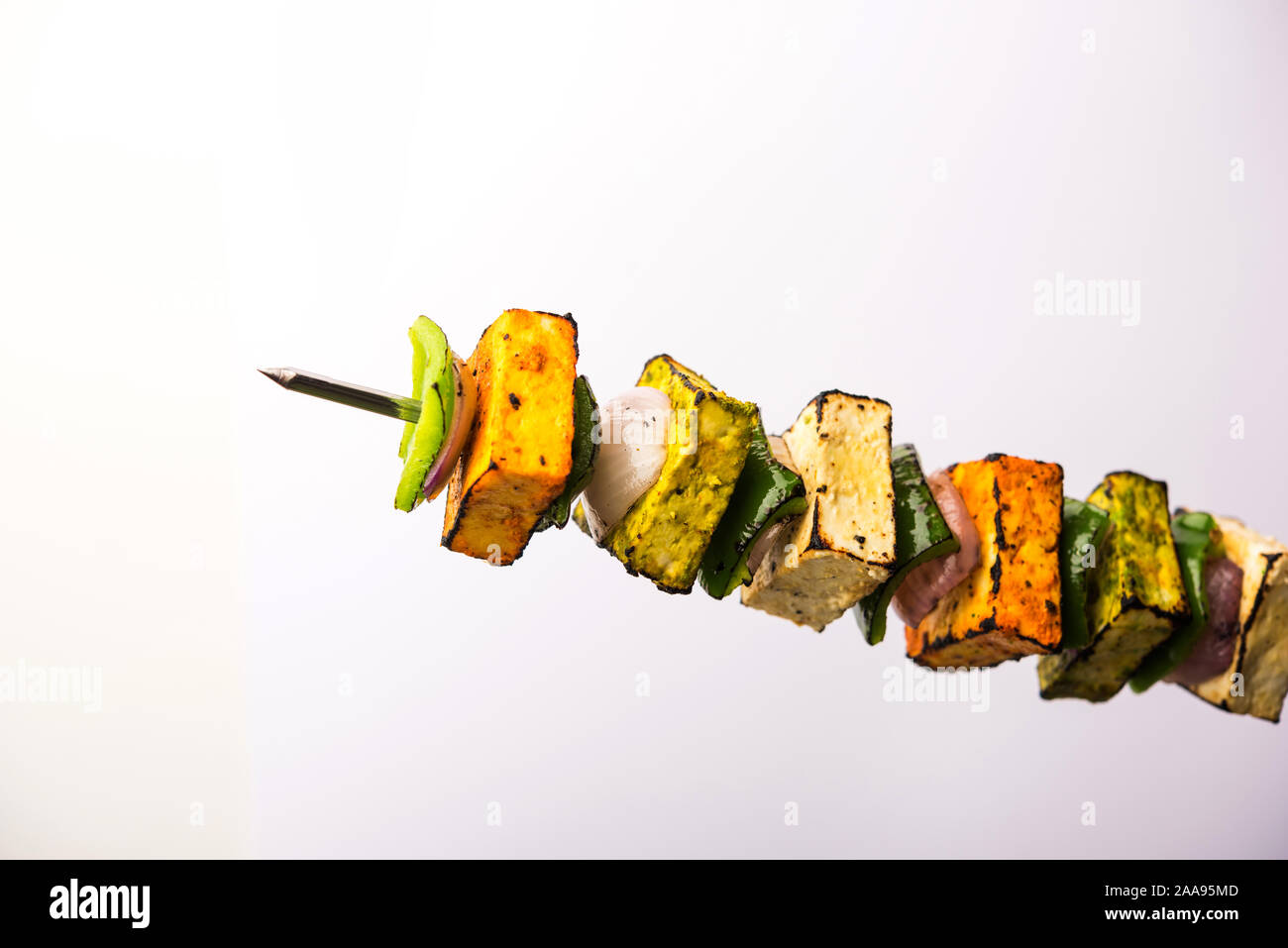 Flying Paneer Tikka isolated over white or black background, selective ...
