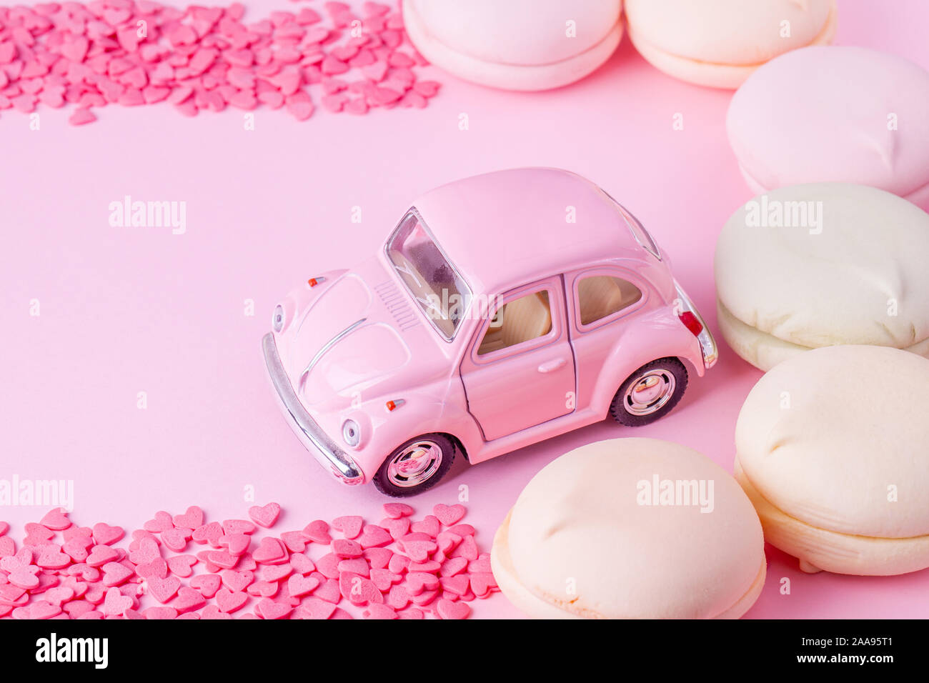 Retro toy car on pink background with frame of hearts and colored ...
