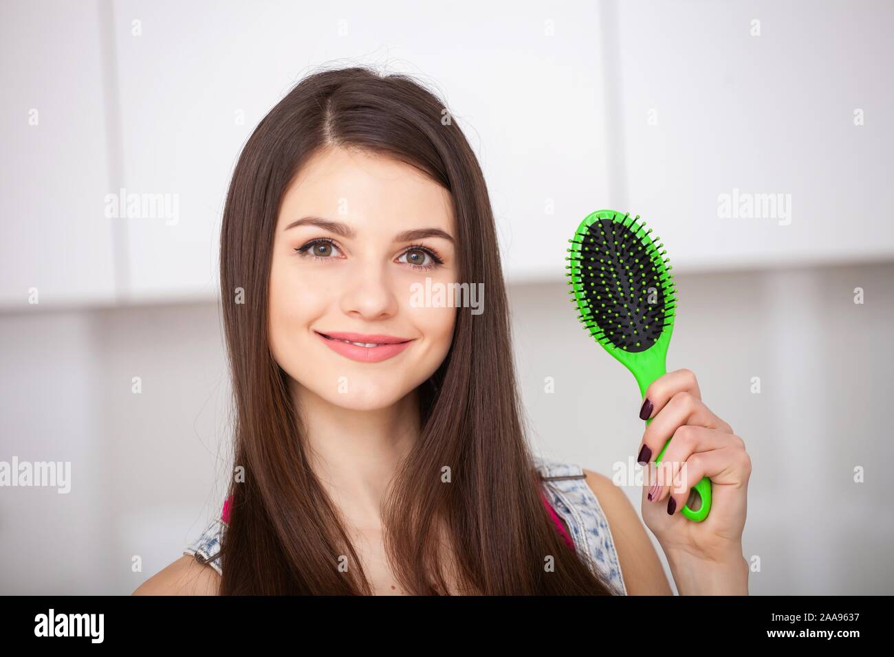 Girl holds a hairbrush without hair and smiling Stock Photo - Alamy