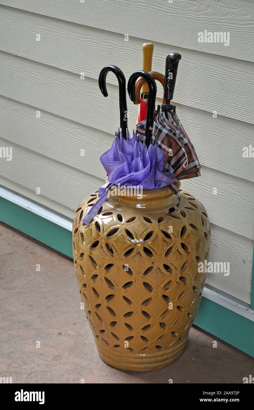 Decorative ceramic umbrella stand filled with colorful umbrellas Stock ...