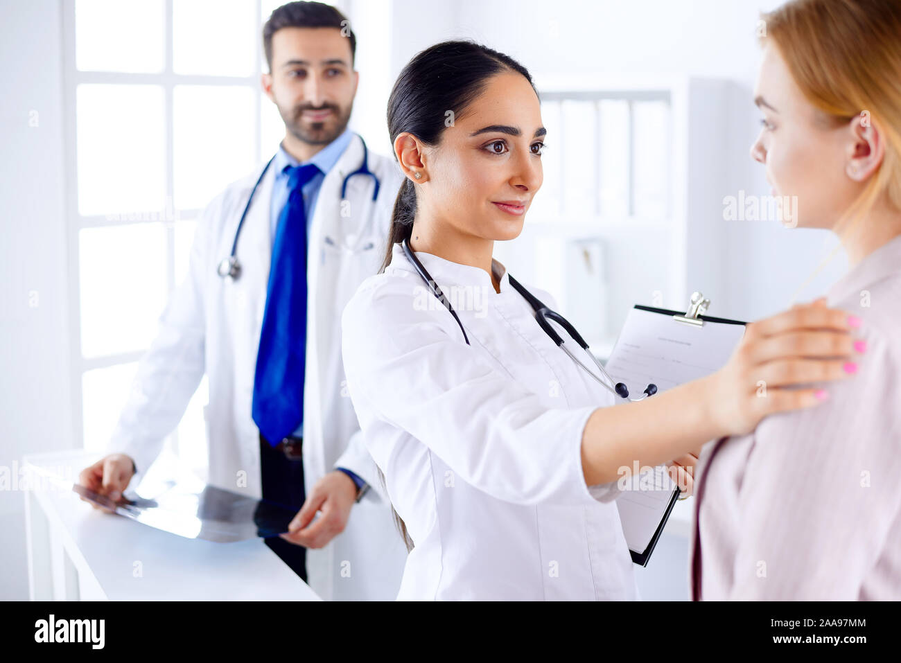 Young Arabian female doctor explains the diagnosis to a patient in a ...