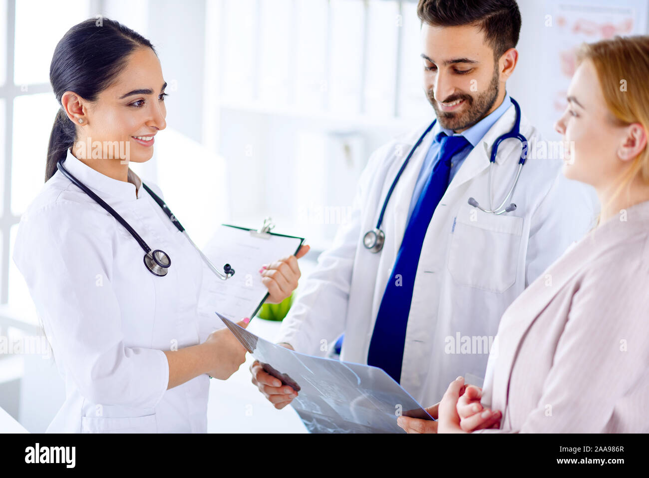 Two doctors communicate with the patient and report the diagnosis to ...