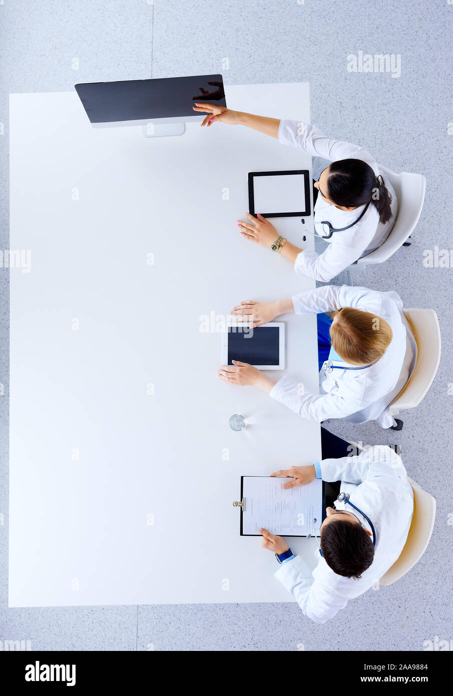 Flat lay, top view. Group of doctors with tablets and computers at ...