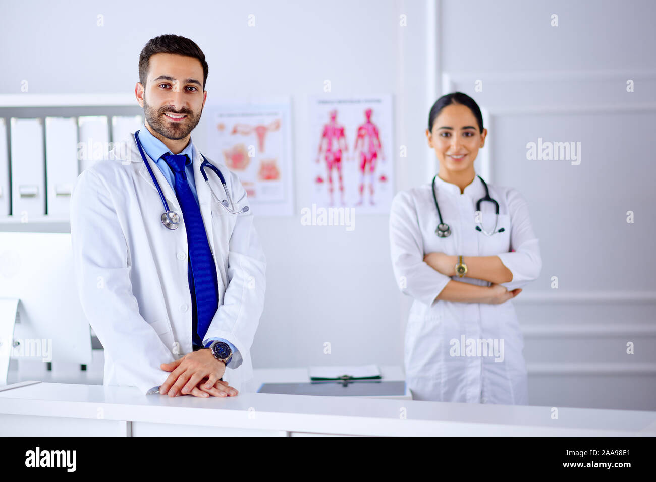 Two young arab doctors standing in consultation room in hospital Stock ...