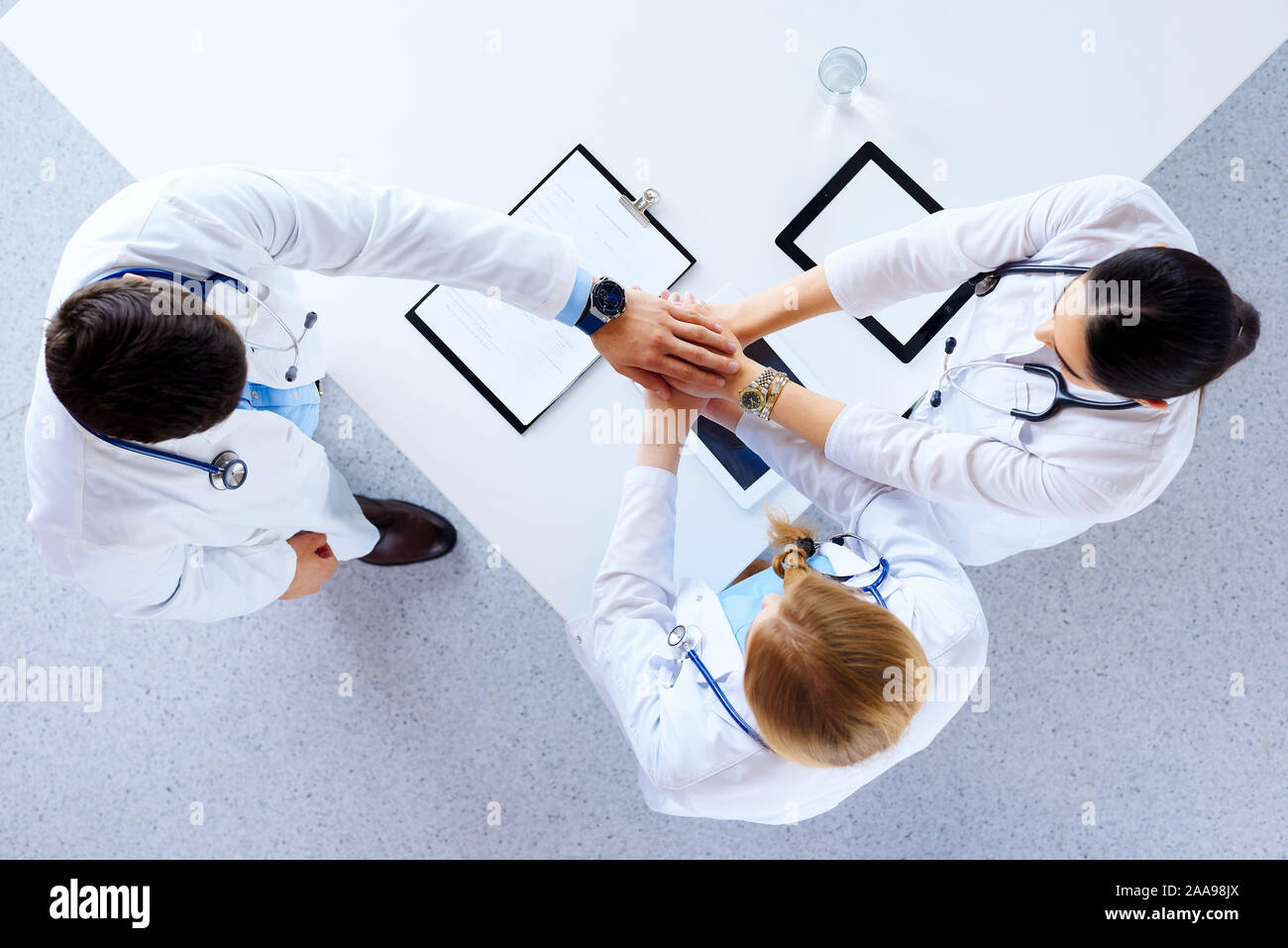 Flat lay, top view. Professional doctors handshaking at hospital. Group ...