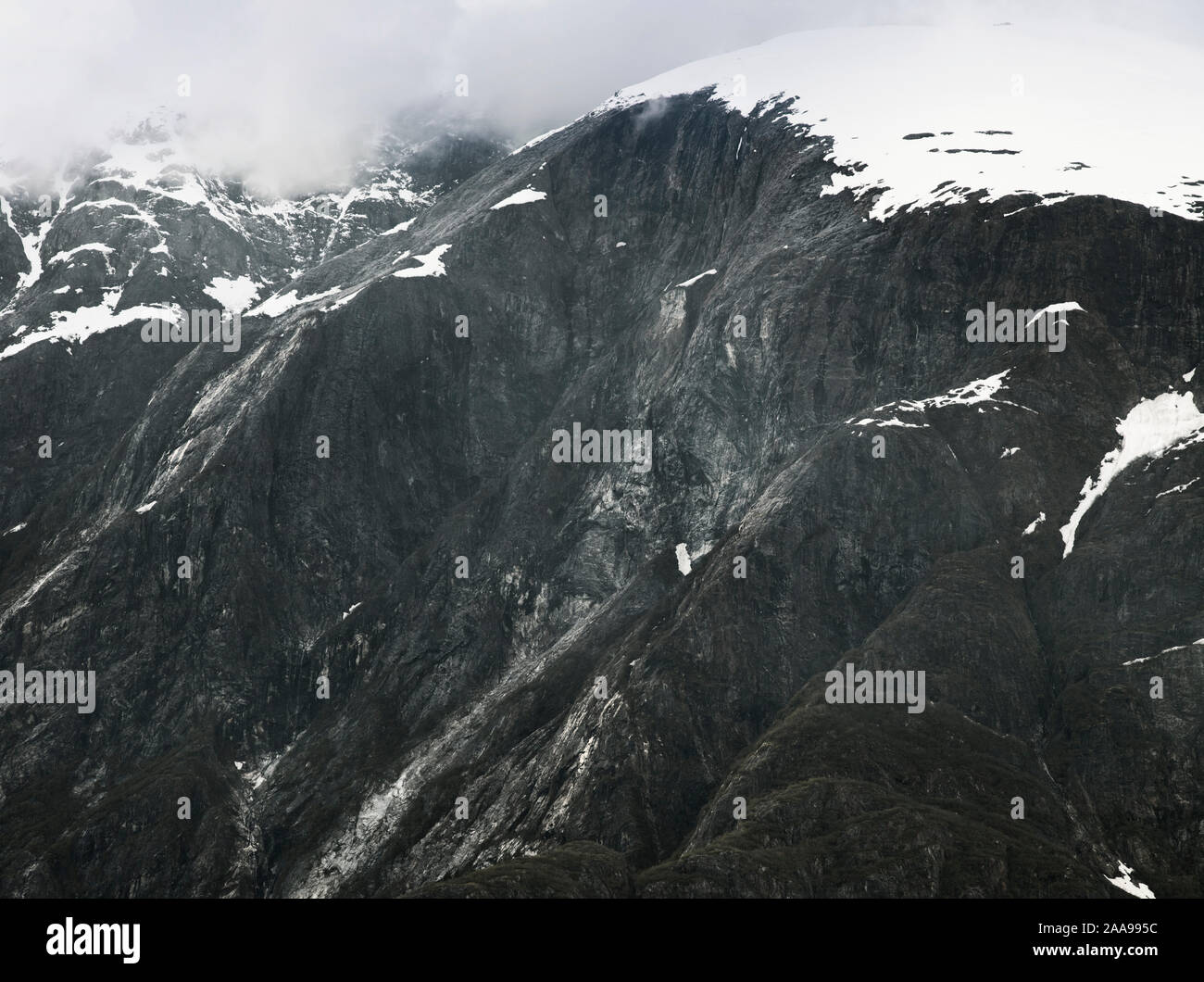 Steep Glacially Polished Cliffs And Mountain Peak Covered With Snow And ...