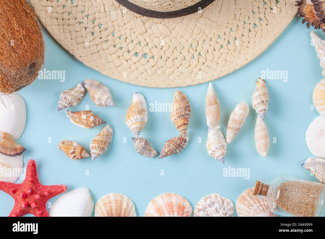 The word sun written in shells on blue background Stock Photo - Alamy