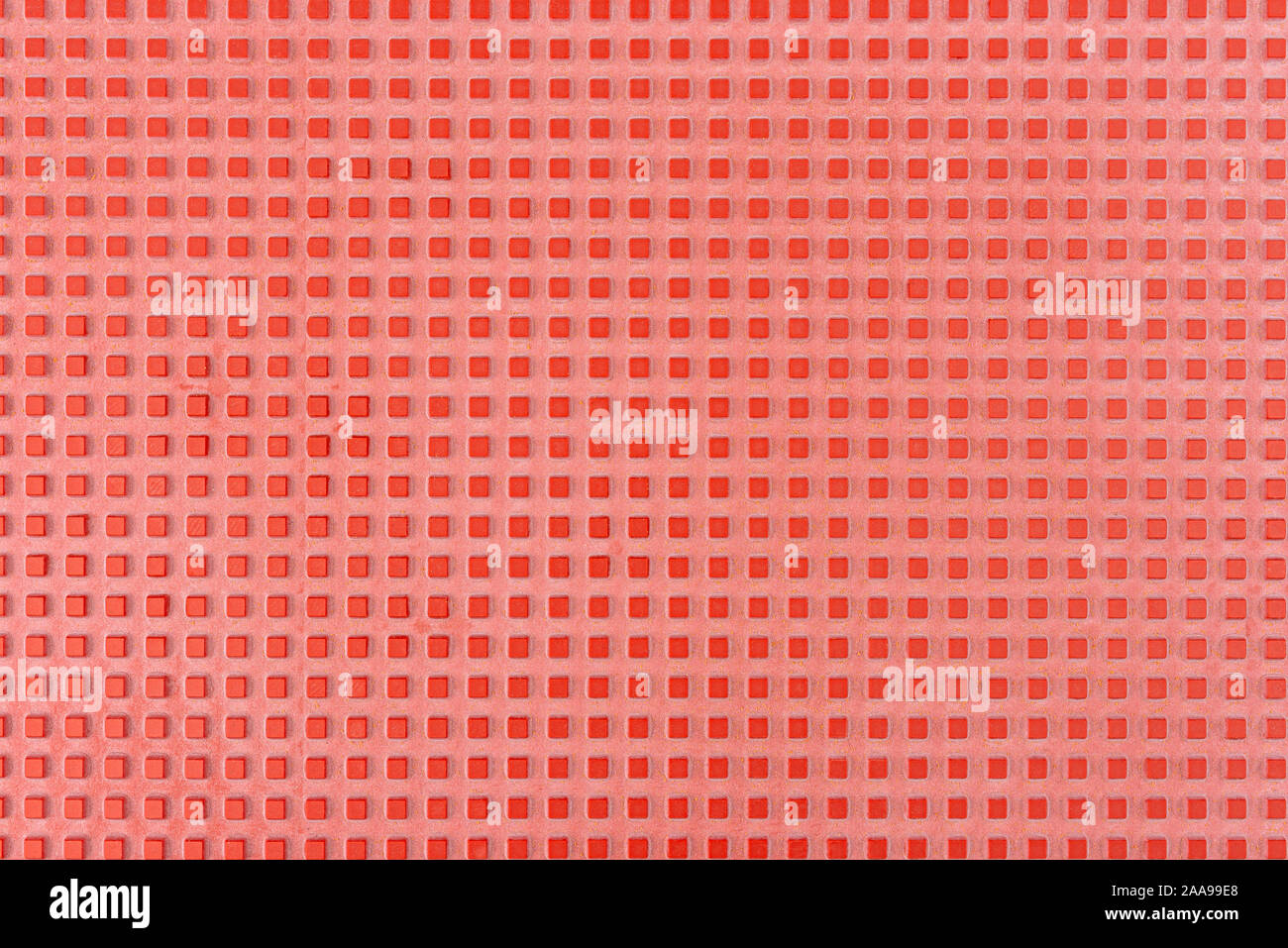 Real texture of pink rubber squares close up, illuminated with light ...