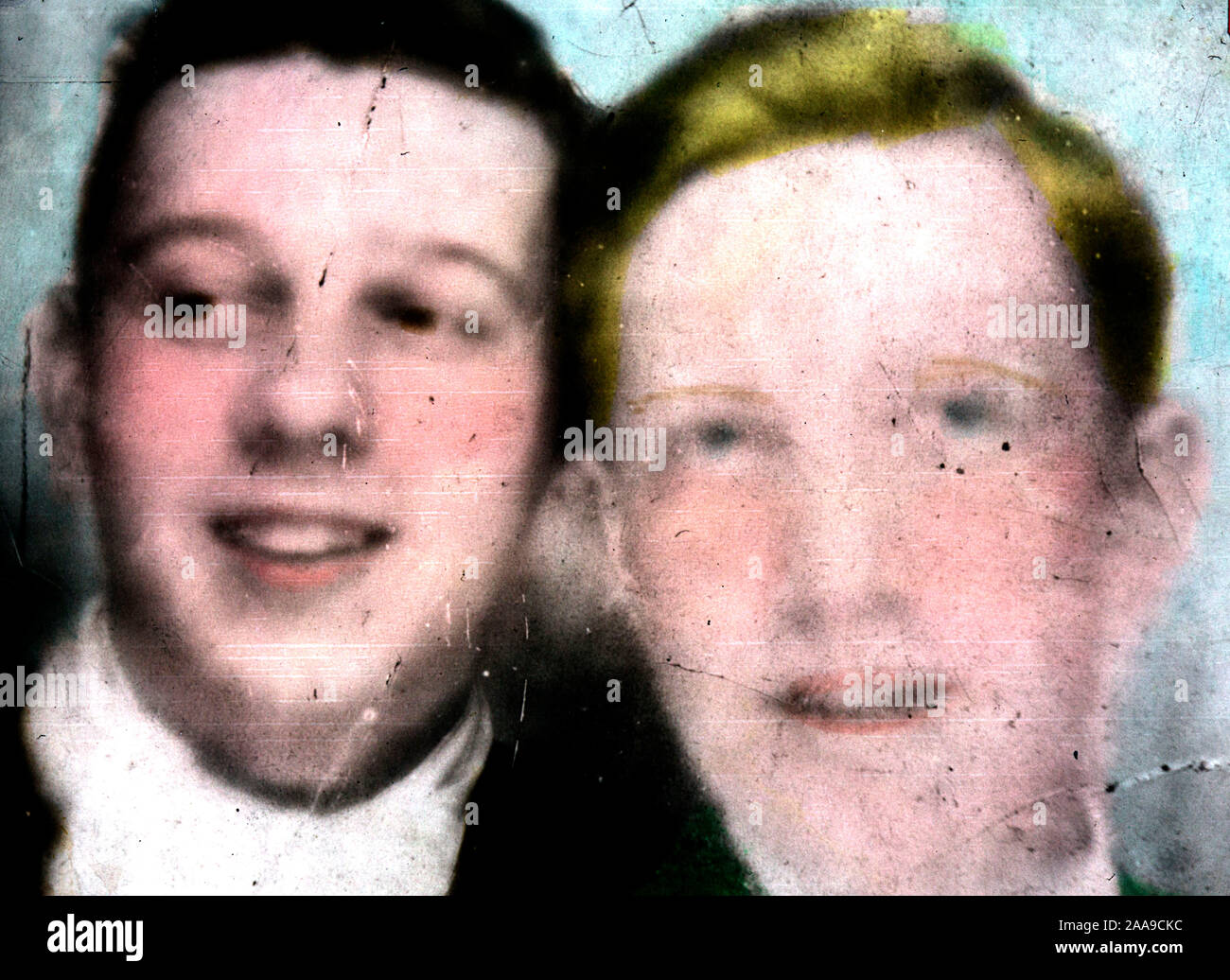 Out of focus and blemished colorized photo booth photo of two buddies ...
