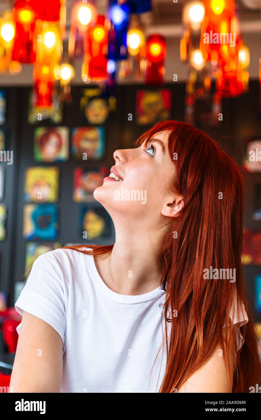 Young girl turned in profile, looks up and smiles Stock Photo - Alamy