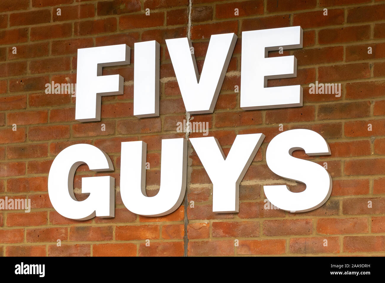 The sign of a Five guys restaurant on a brick building Stock Photo - Alamy