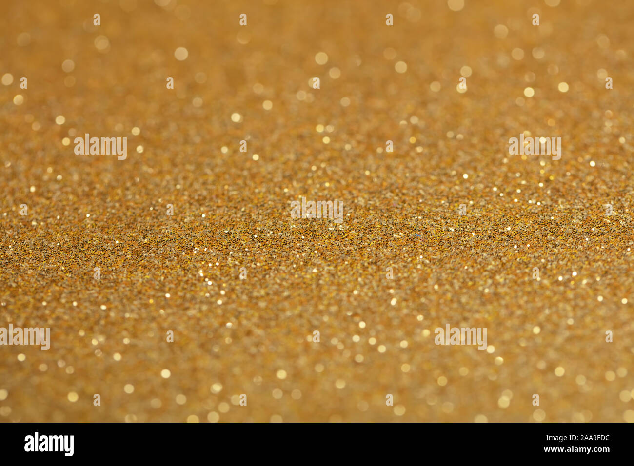 Background golden sparkles with bokeh.Gilded paper for background Stock ...