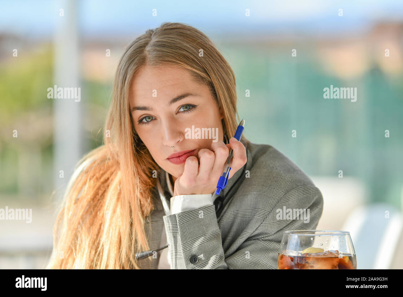 Cute young woman in office with relaxed posture. Customer service agent ...