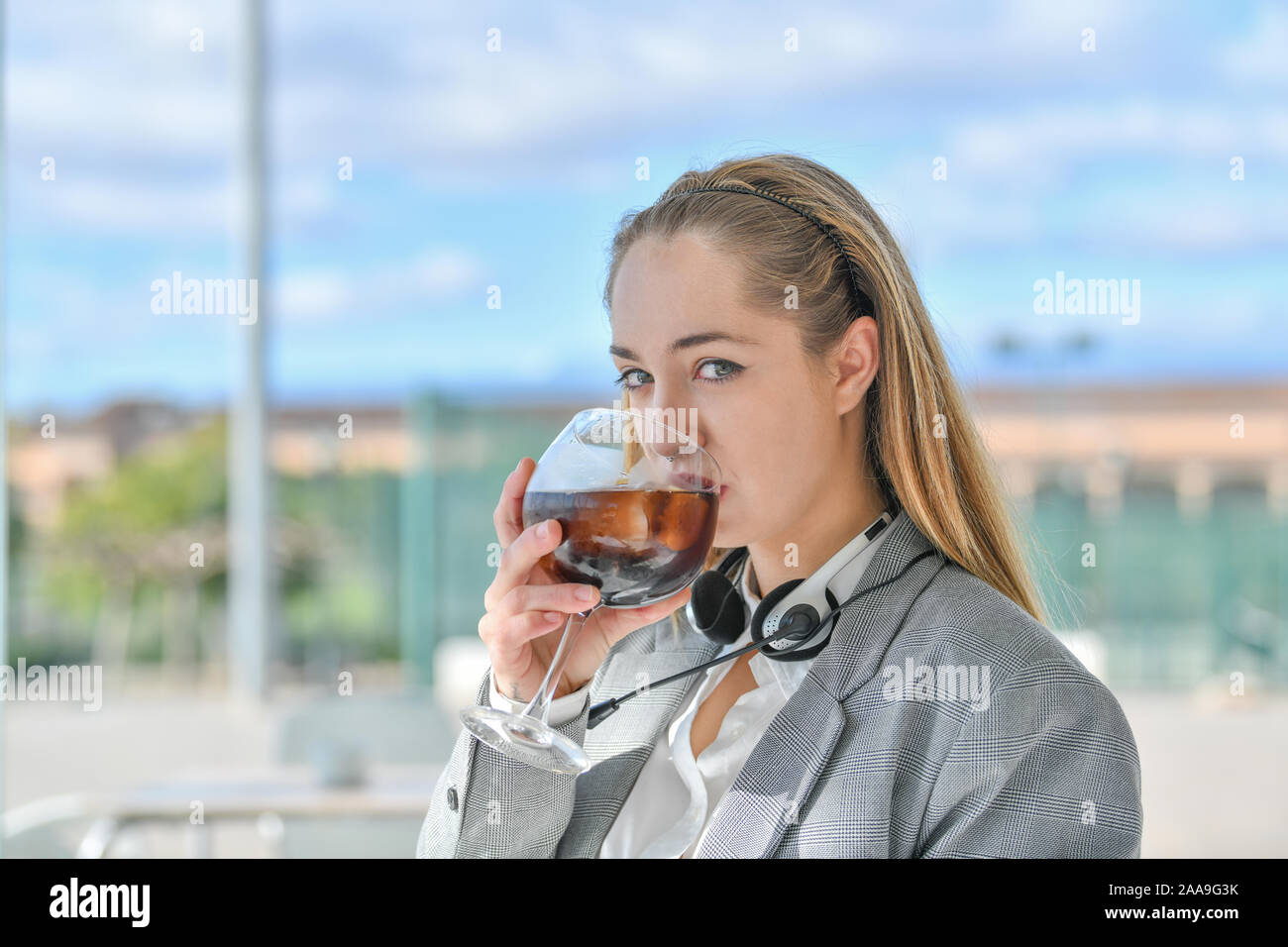 Young woman drinking a soda at call center office and working. Customer ...
