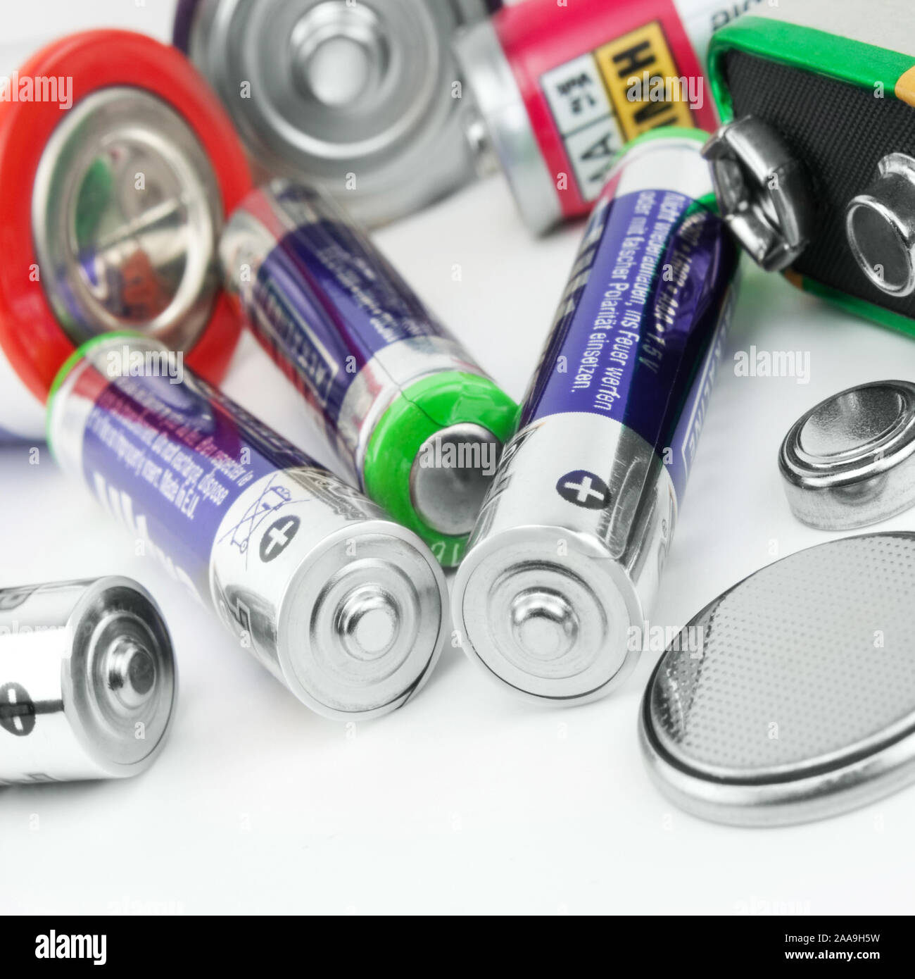 Various batteries close up on whit background Stock Photo - Alamy