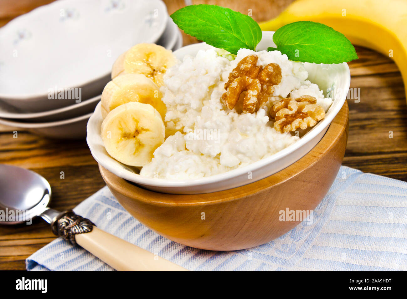 Cottage cheese with walnuts and banana Stock Photo - Alamy