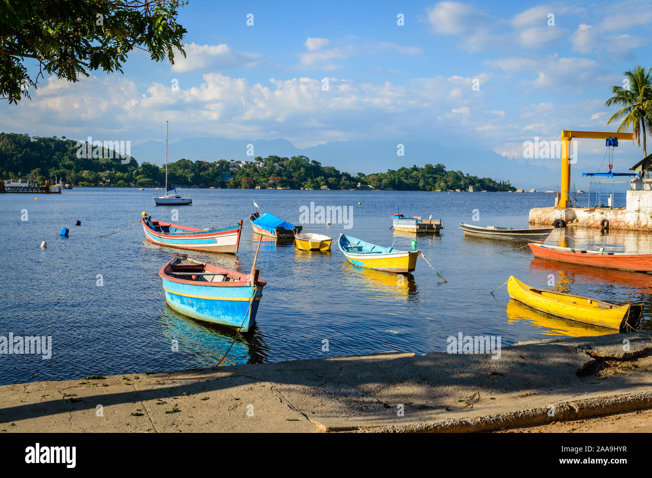 Colorful wooden canoes docked on calm waters at Paquetá Island, Rio de ...