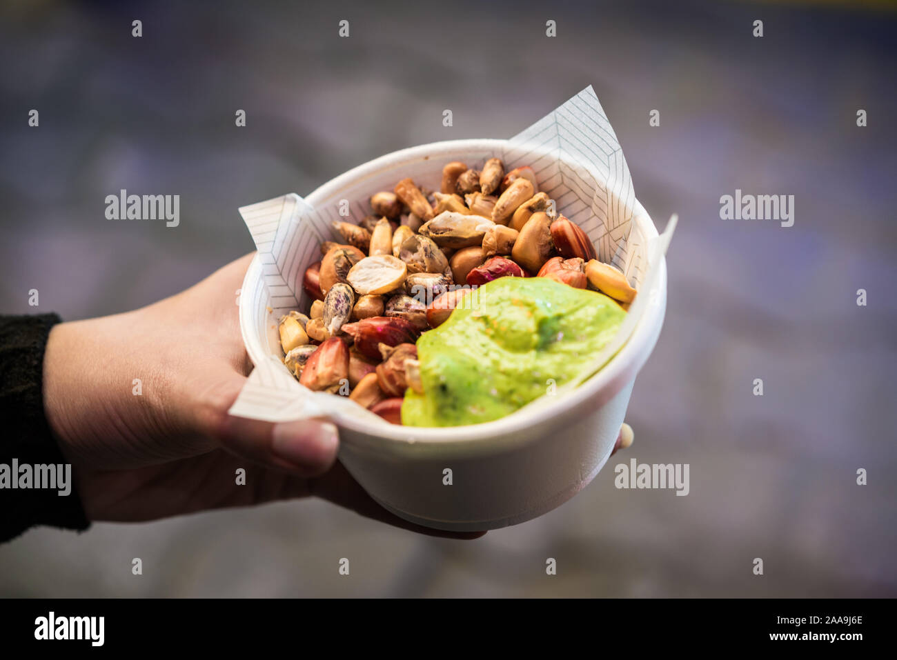 Fried Andean corn maize with chilli sauce at a street food market ...