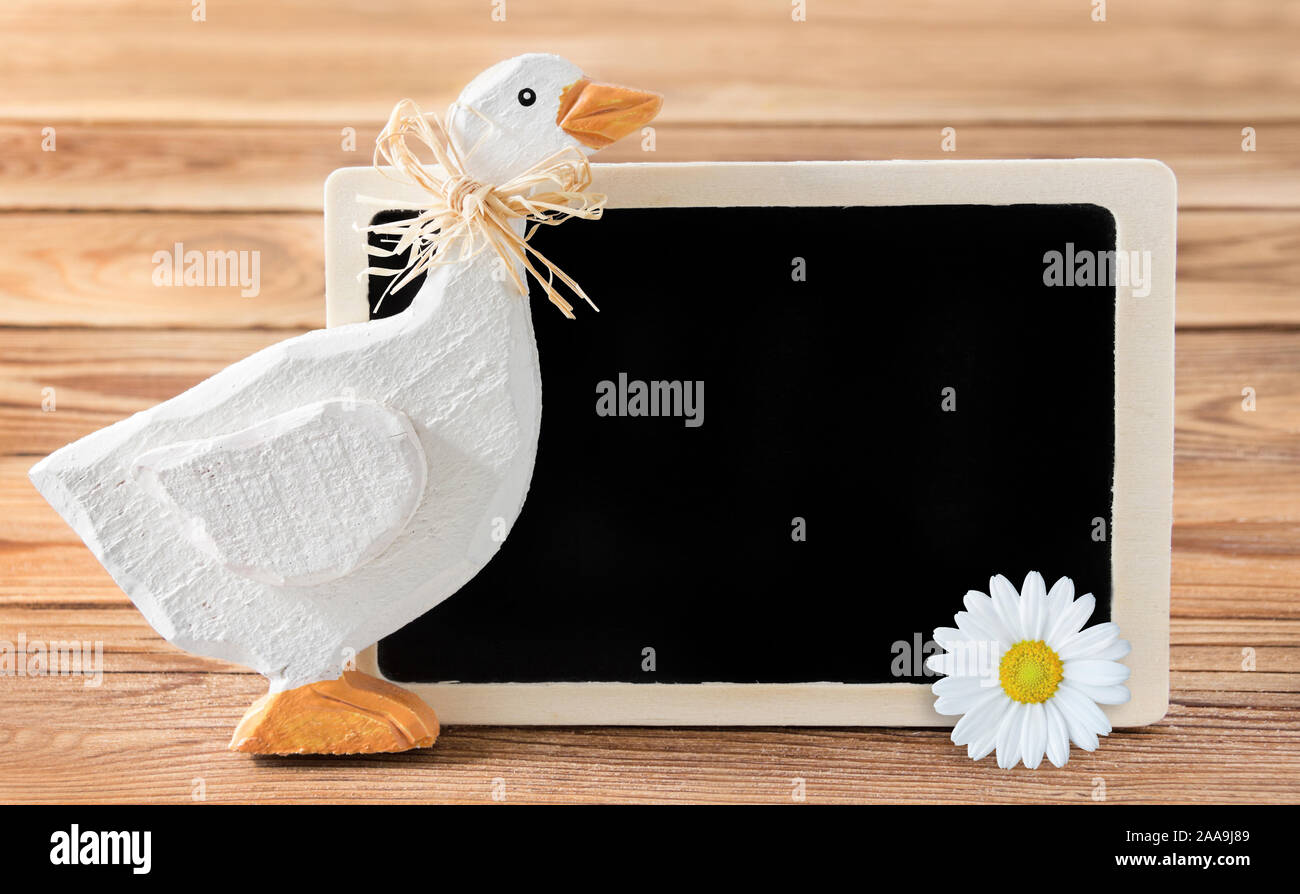 Wooden goose and board background Stock Photo - Alamy
