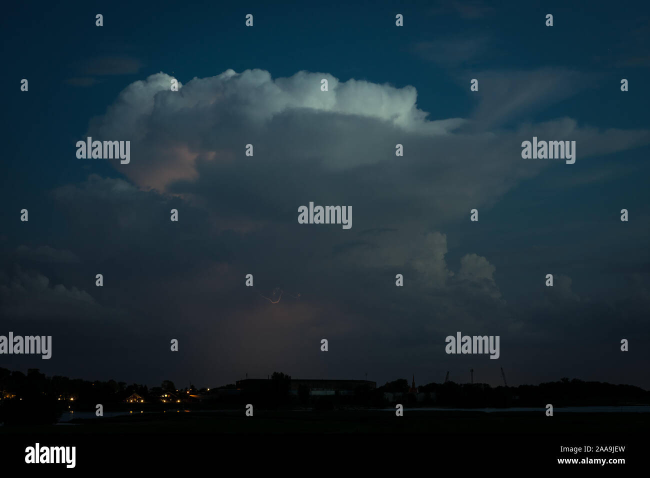 An isolated storm cloud (Cumulonimbus) is illuminated by lightning ...