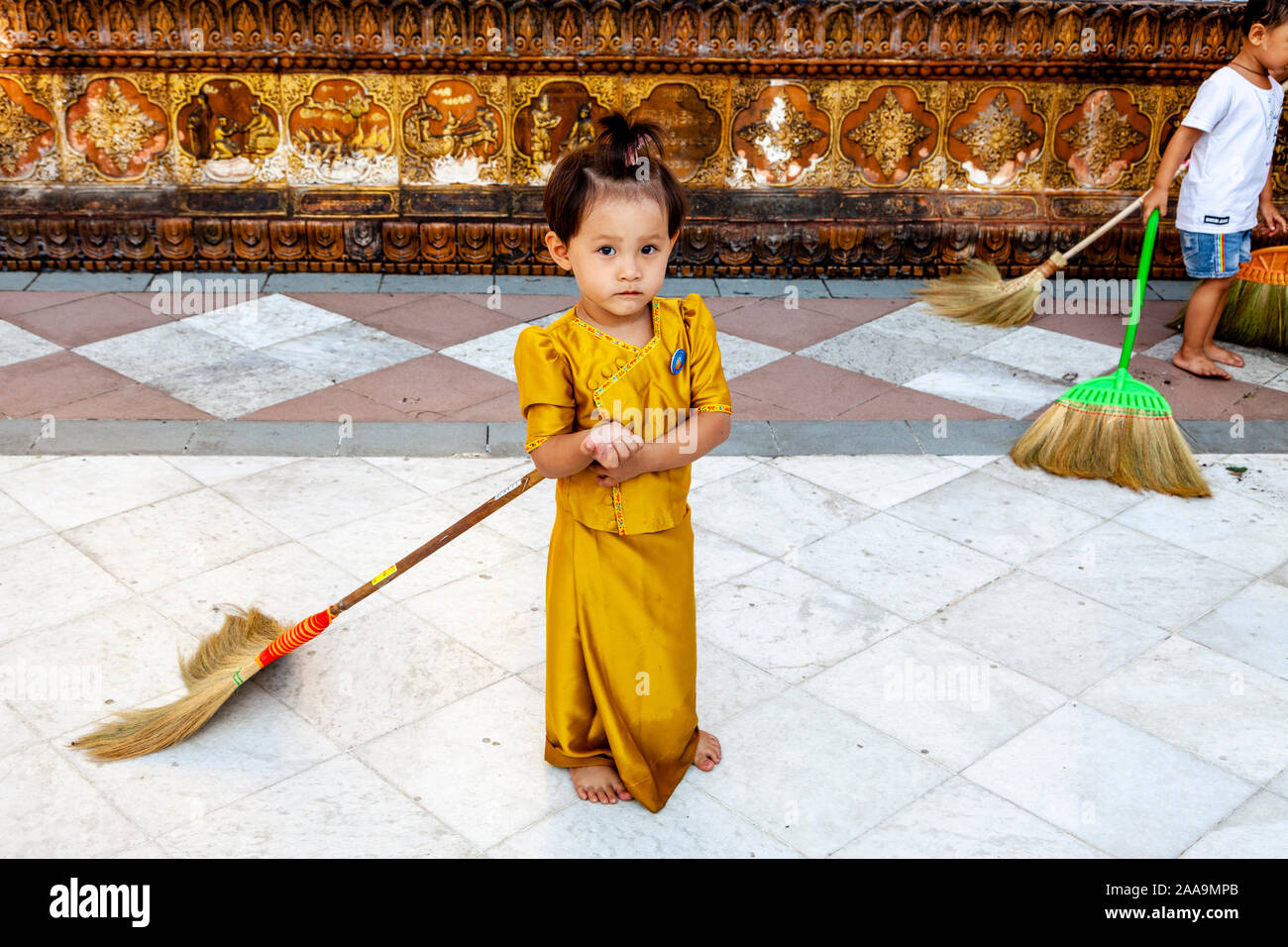 A Child Sweeping The Floor Of The Shwedagon Pagoda, Yangon, Myanmar ...