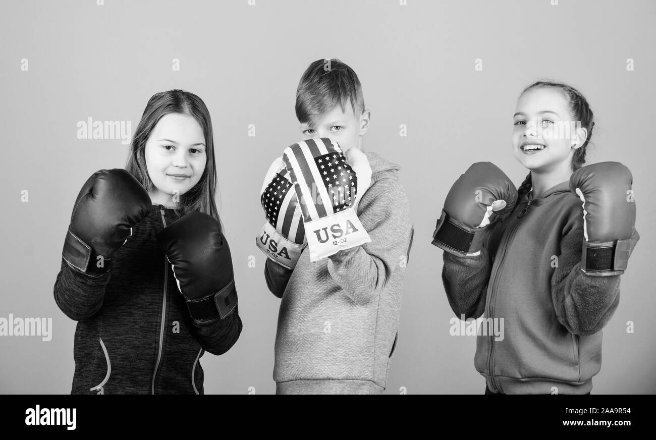 Friendly sparring. Boy and girls friends wear boxing gloves with usa ...