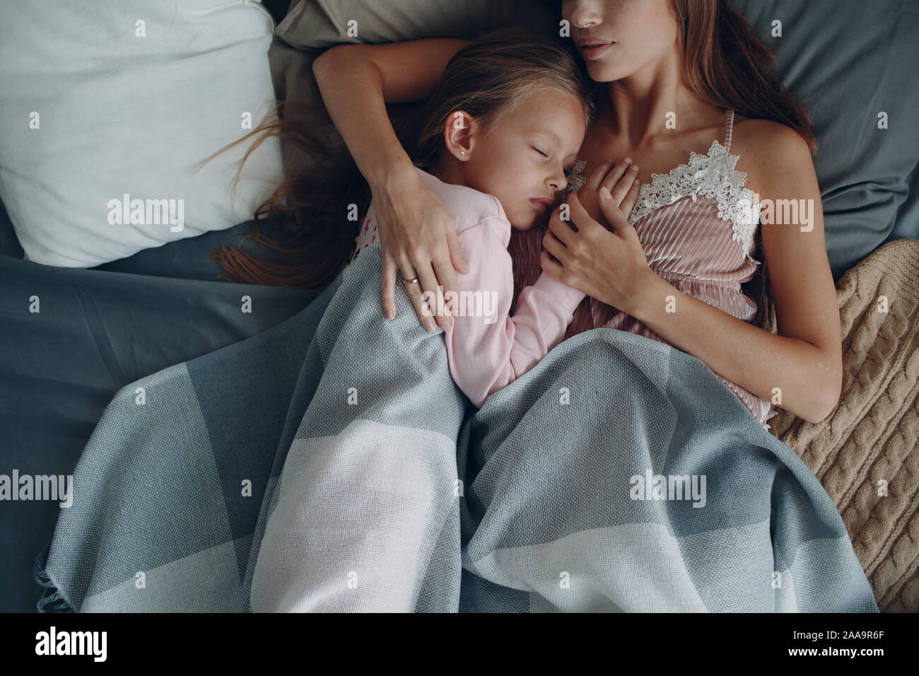 Mother sleep hugging with little daughter girl. Family and mother's day ...