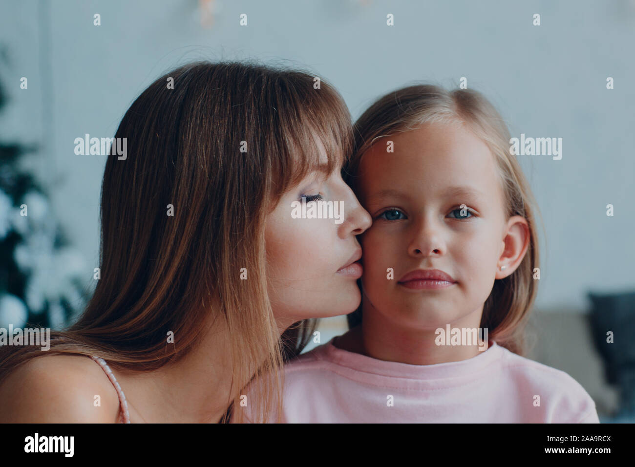 Close up of a daughter kissing her mother hi-res stock photography and images - Alamy