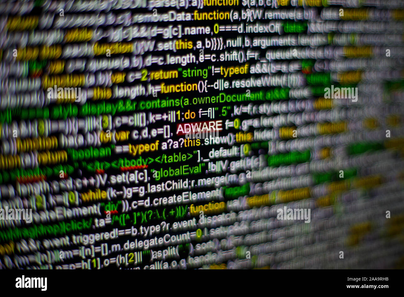 Macro Photo Of Computer Screen With Program Source Code And Highlighted Adware Inscription In 