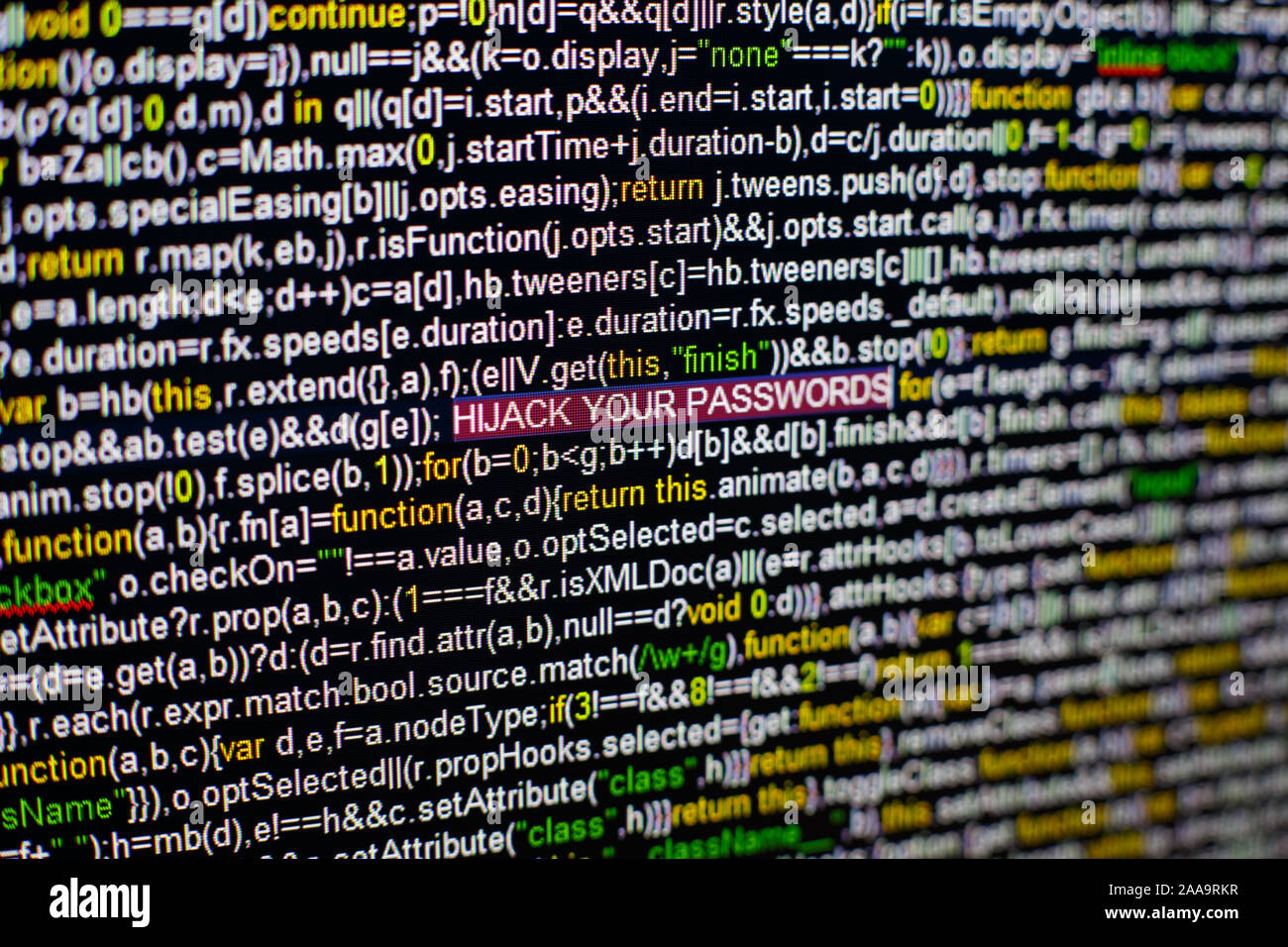 Macro photo of computer screen with program source code and highlighted HIJACK YOUR PASSWORDS ...