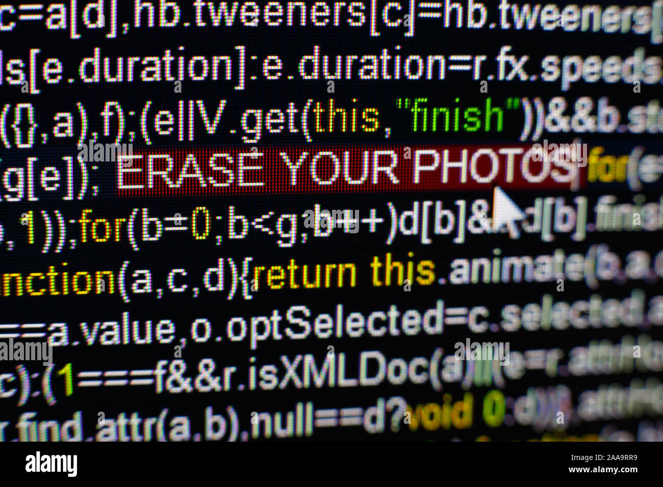 Macro photo of computer screen with program source code and highlighted ERASE YOUR PHOTOS ...