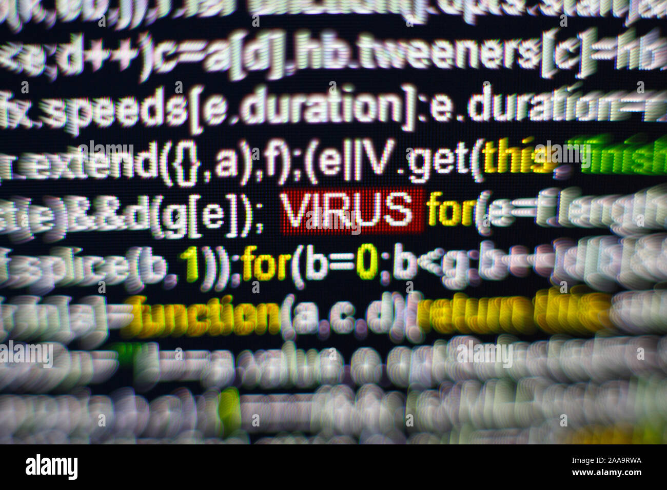 Macro photo of computer screen with program source code and highlighted VIRUS inscription in the ...
