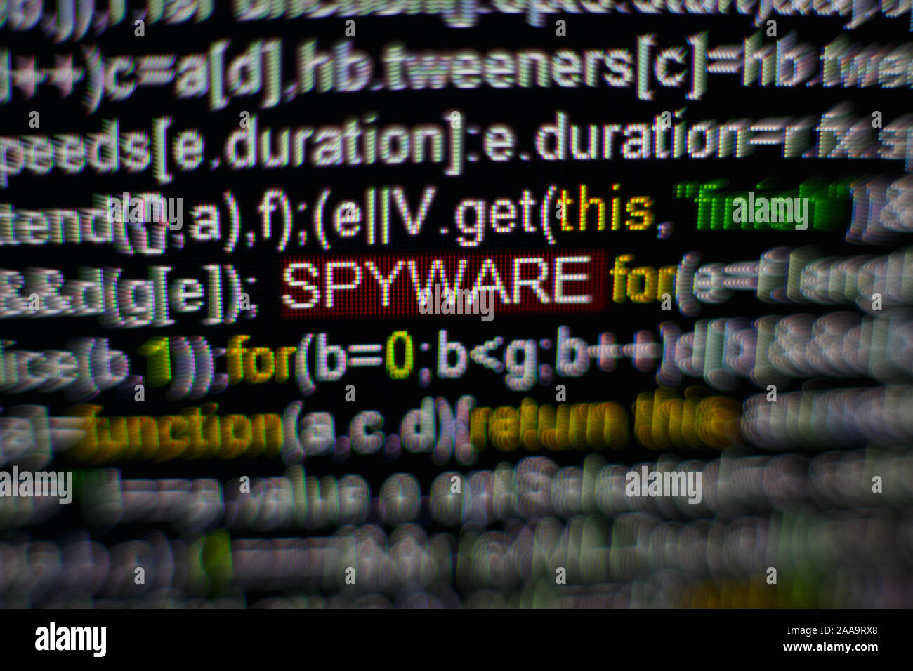 Macro photo of computer screen with program source code and highlighted SPYWARE inscription in ...