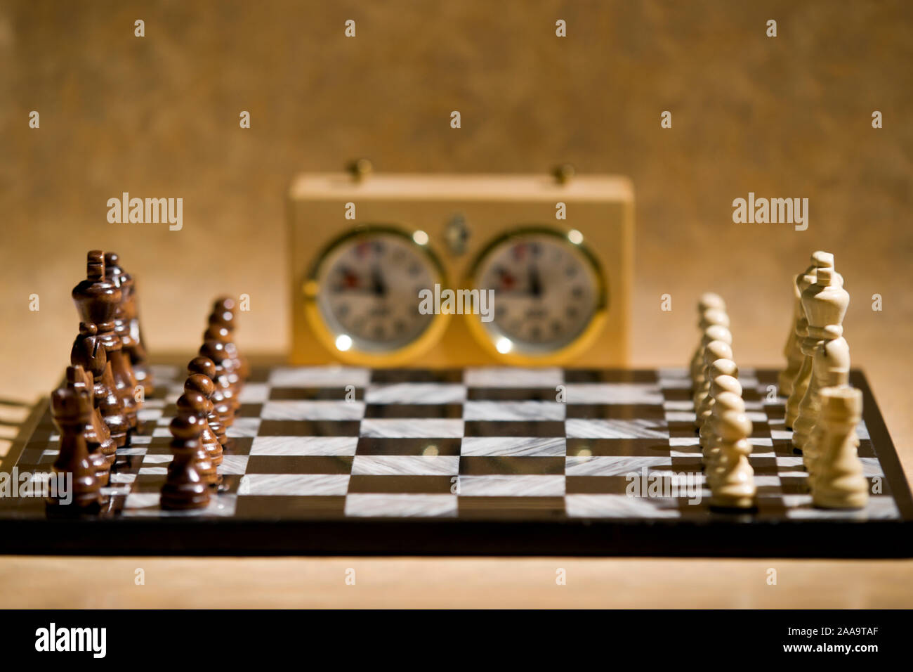 Chess board with pieces and a chess clock Stock Photo - Alamy