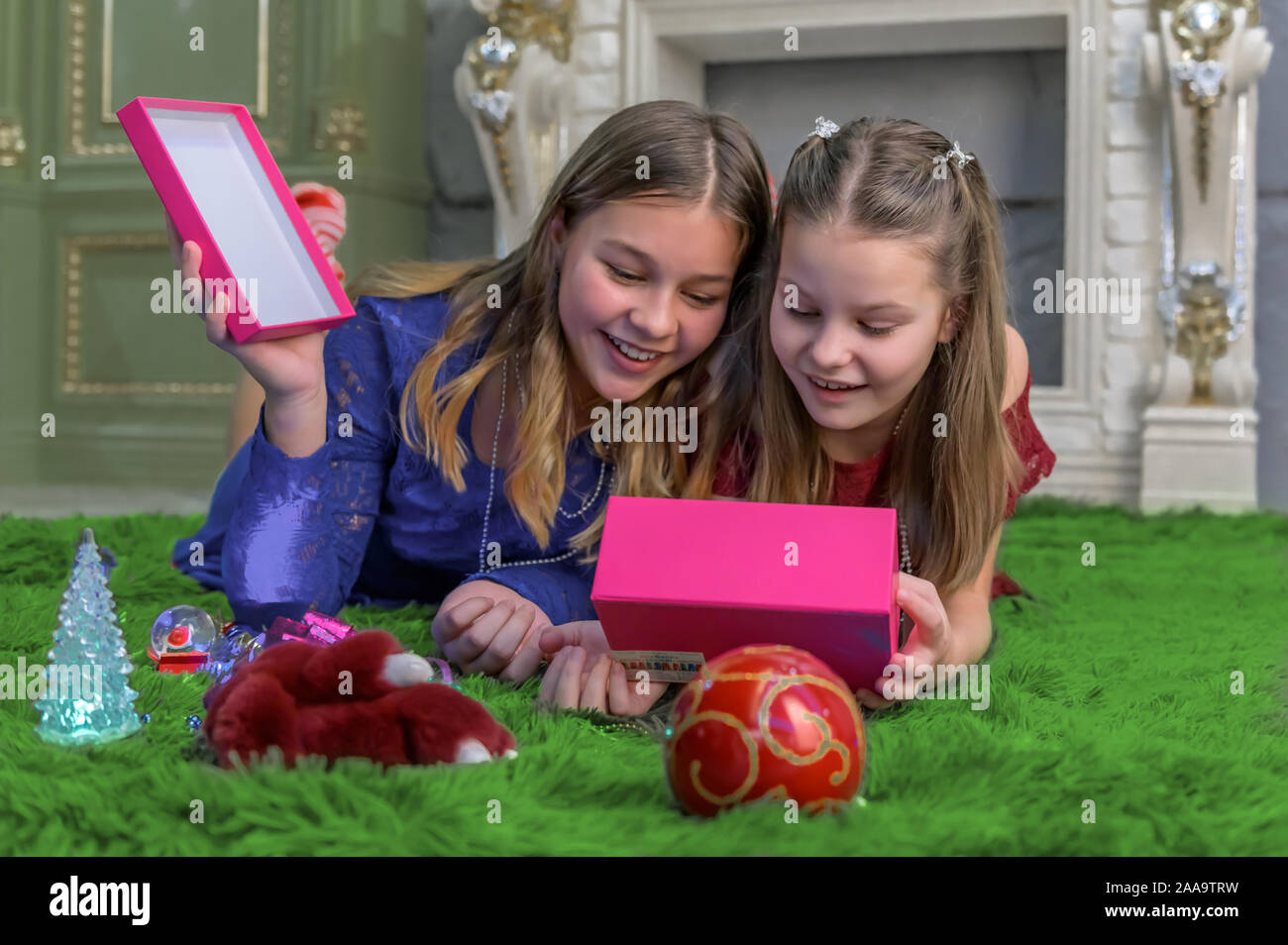 two happy girls open a gift box Stock Photo - Alamy